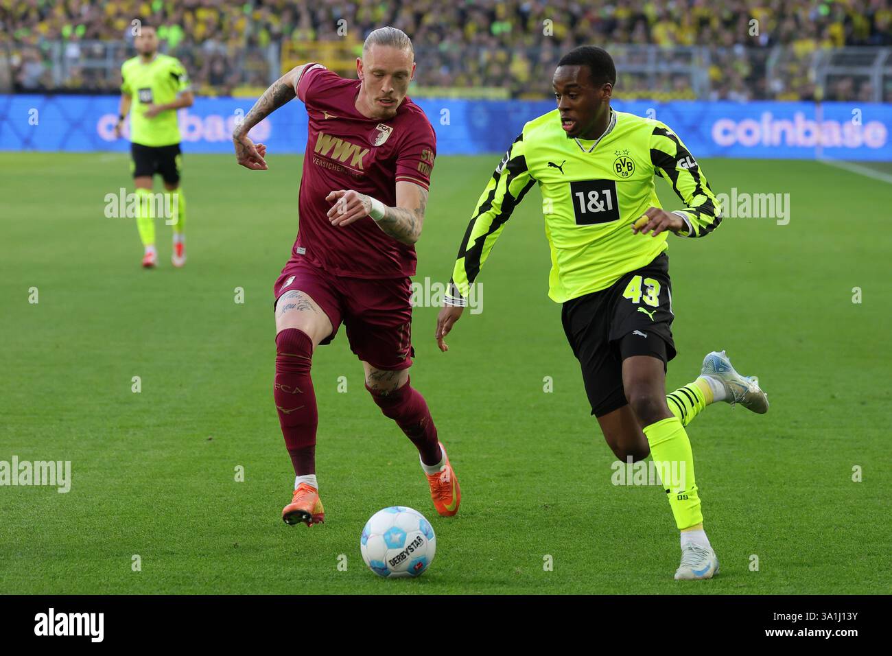 Dortmund, Germany. 8th Mar, 2025. Jamie Gittens (R) of Borussia Dortmund vies with Marius Wolf ...