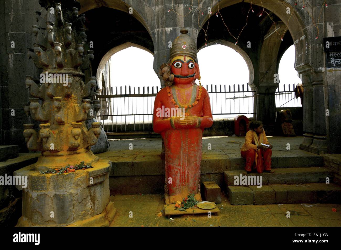 Devotee sitting near statue of lord Khandoba god of Jejuri Mahalsakant ...