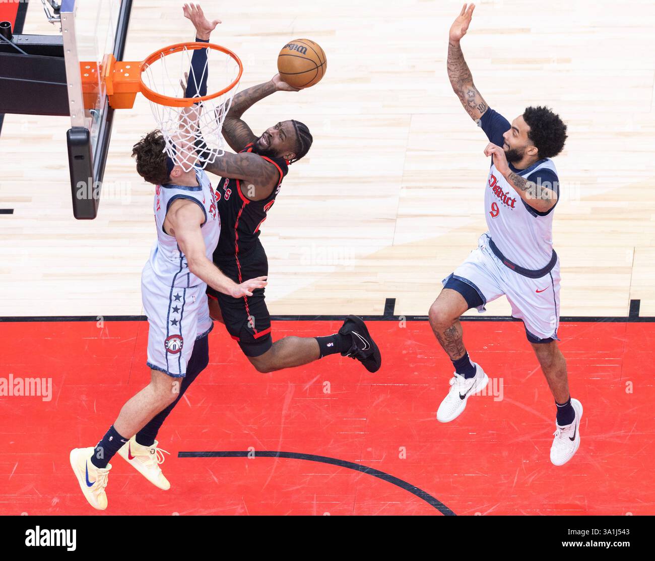 Toronto, Canada. 8th Mar, 2025. Jamal Shead (C) of Toronto Raptors goes ...