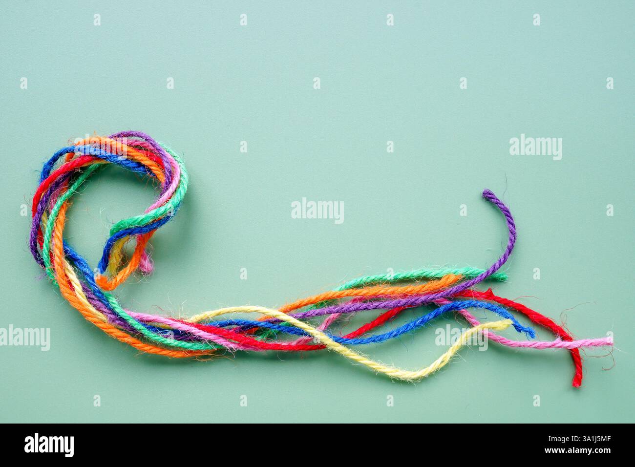 Twisted multicolored threads forming a rope. Unity and teamwork Stock ...
