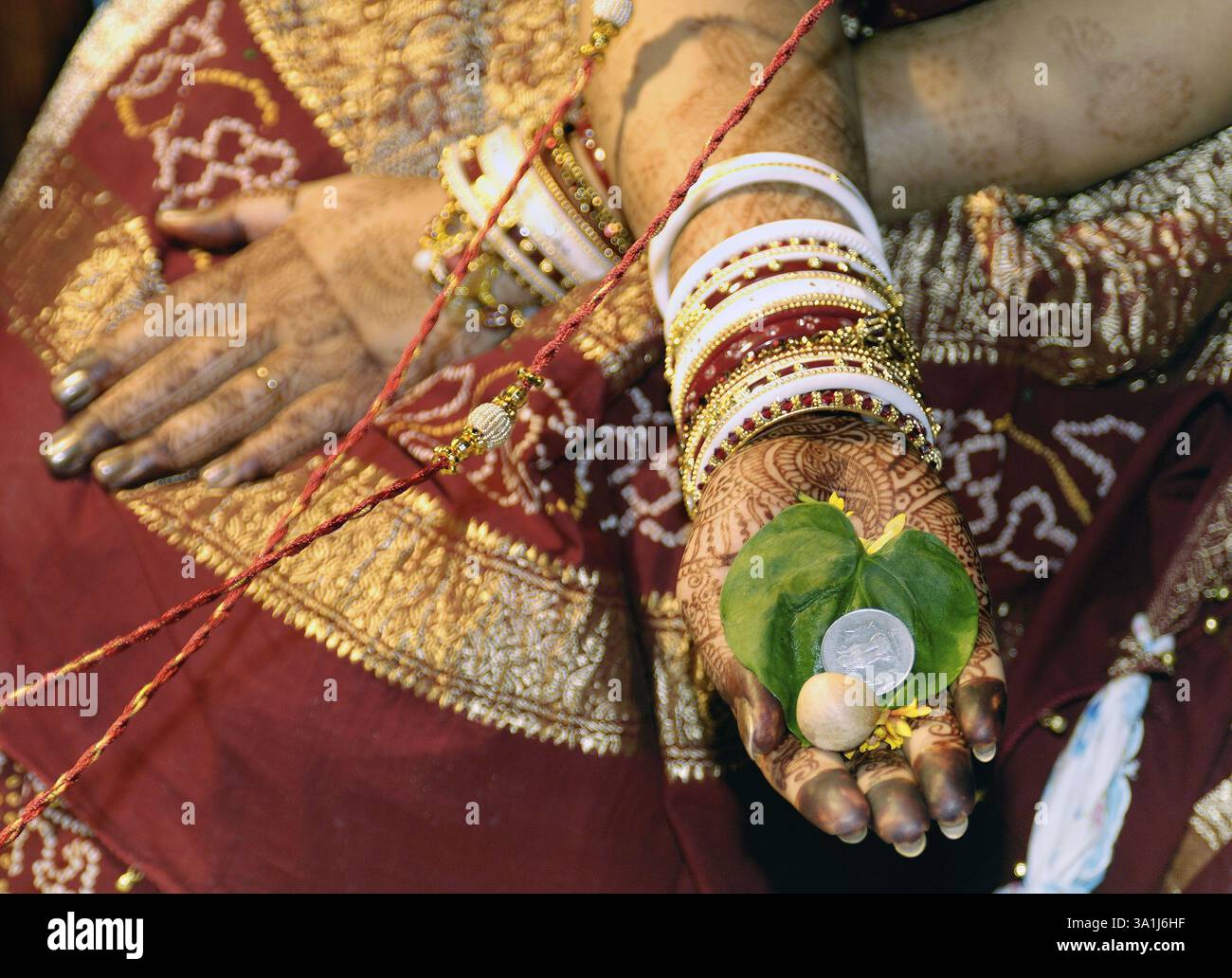 Betel leaf supari and coin in hand palm of bride performing vidhi in ...