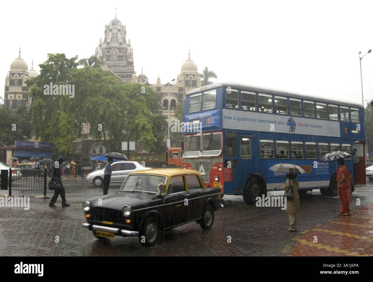 Heavy rain and Churchgate station building people with umbrella and ...