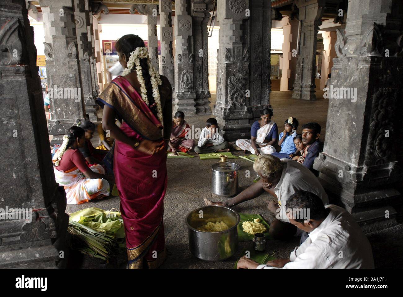 Devotees taking food in temple Urchava mandap of Meenakshi ...