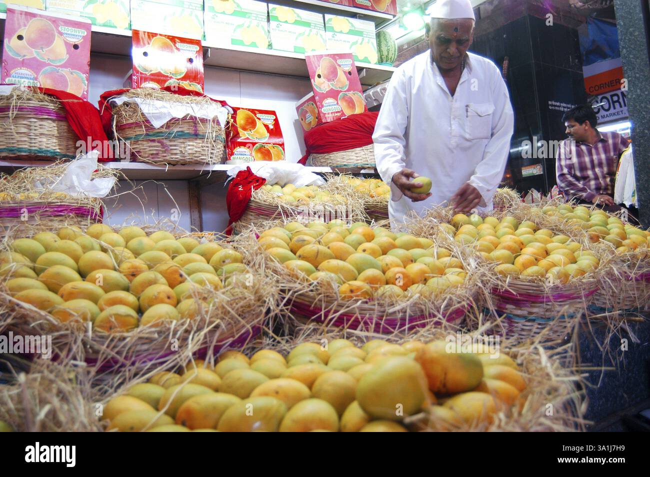 A fruit seller sells Alphonso mangoes at Crawford Market in Bombay NAw Mumbai, Maharashtra ...