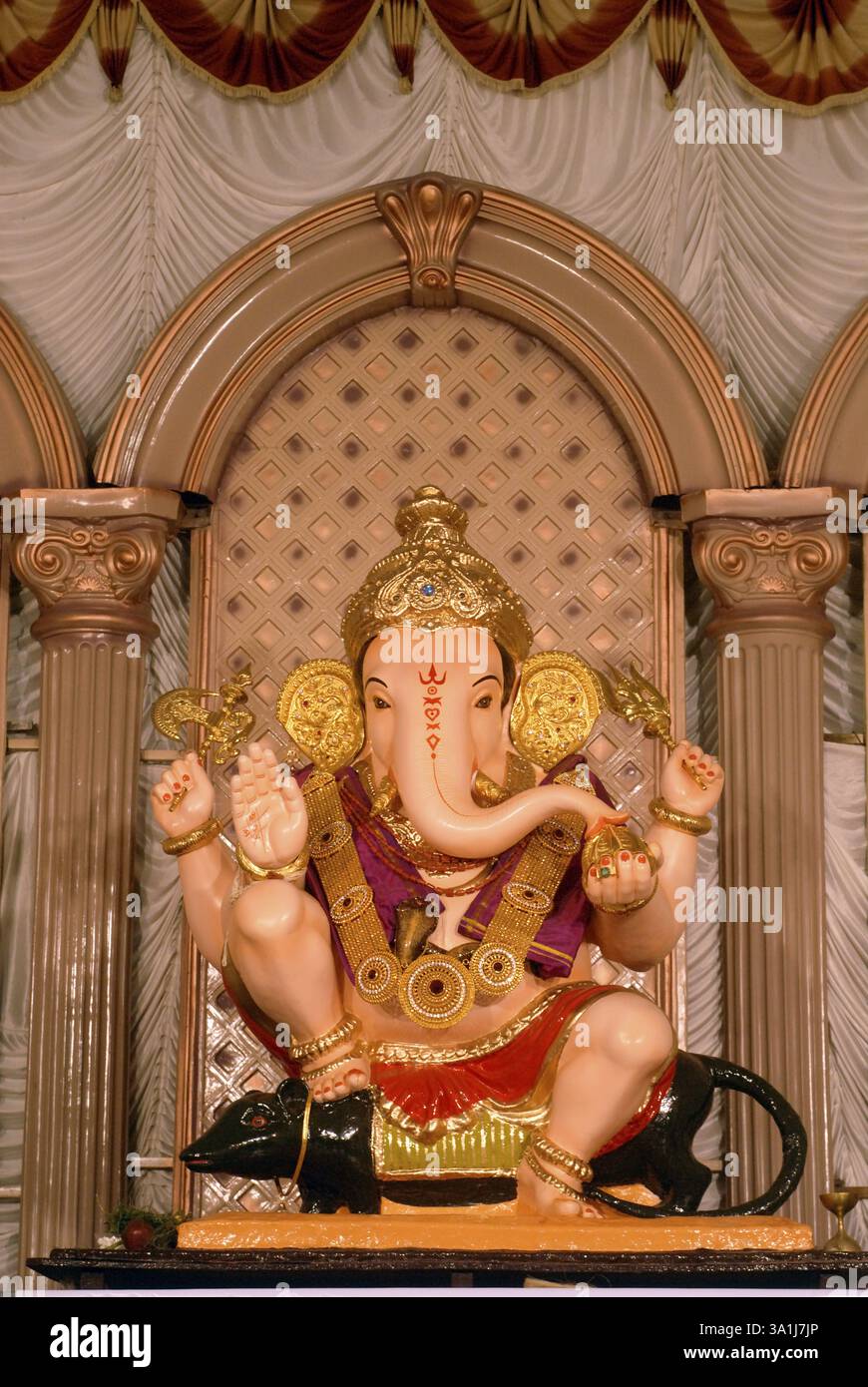 Richly decorated idol of Lord Ganesh sitting on mouse, elephant headed ...