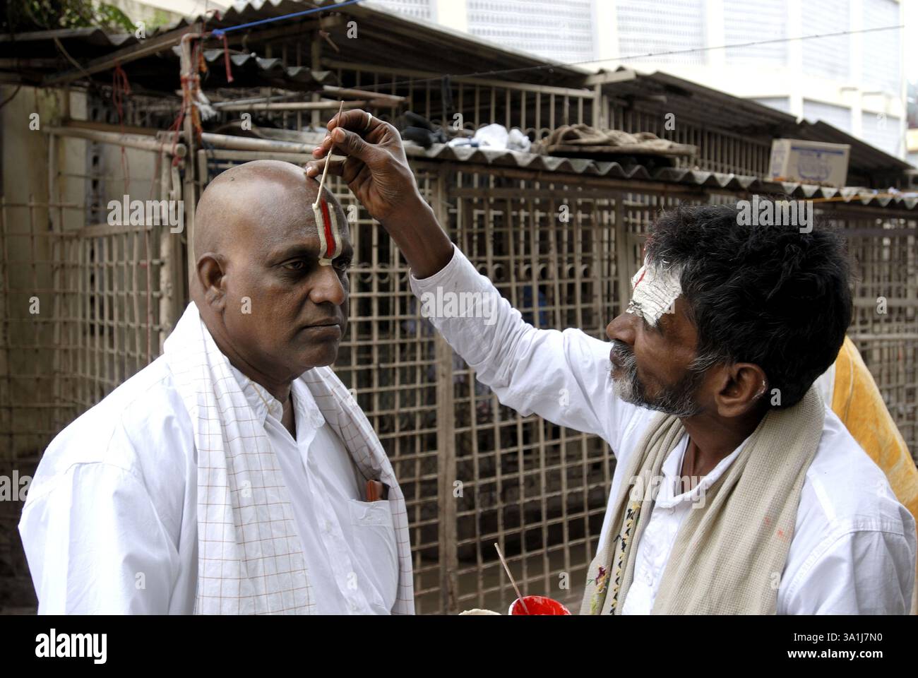 Applying vishnu symbol on the forehead of a Lord Balaji Devotee at ...