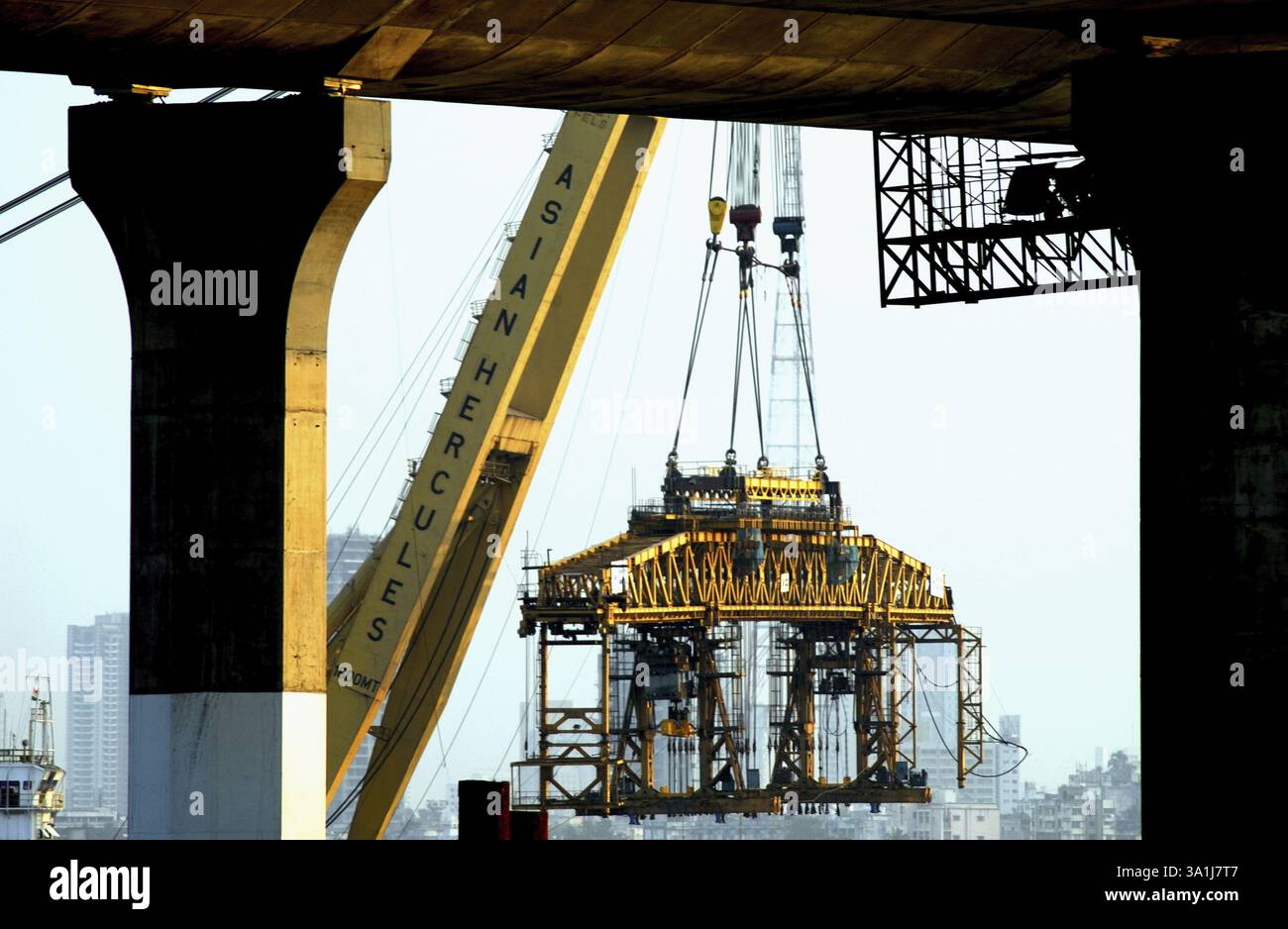 Asian Hercules Crane Carrying Load Looking Through Metal Pillars at ...