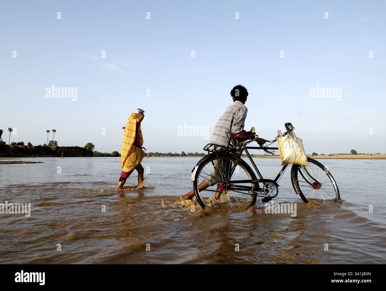 People walking in shallow river water, Garwa and Latehar, Jharkhand ...