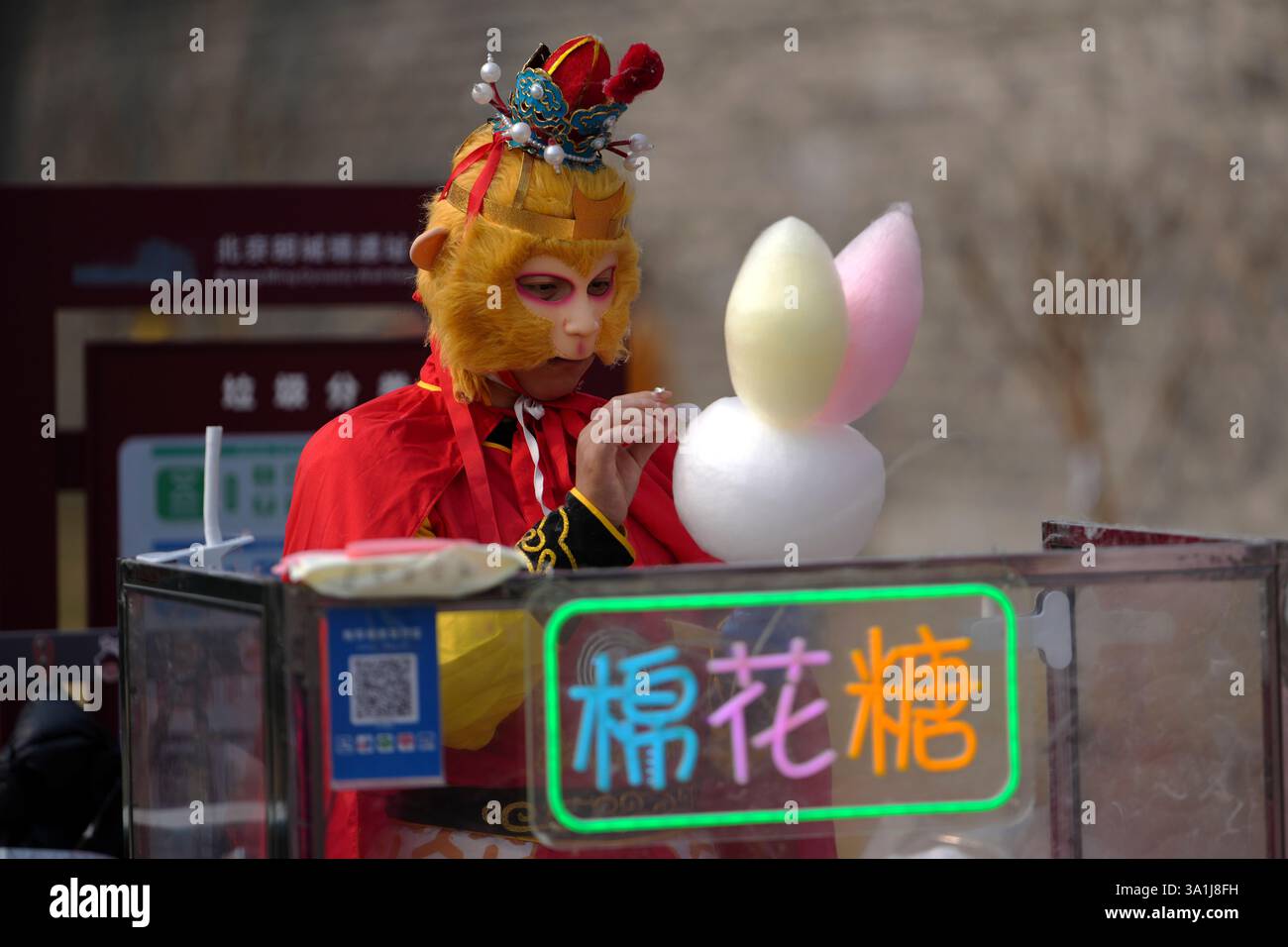 A vendor dressed with Monkey King costume sells cotton candy at the ...