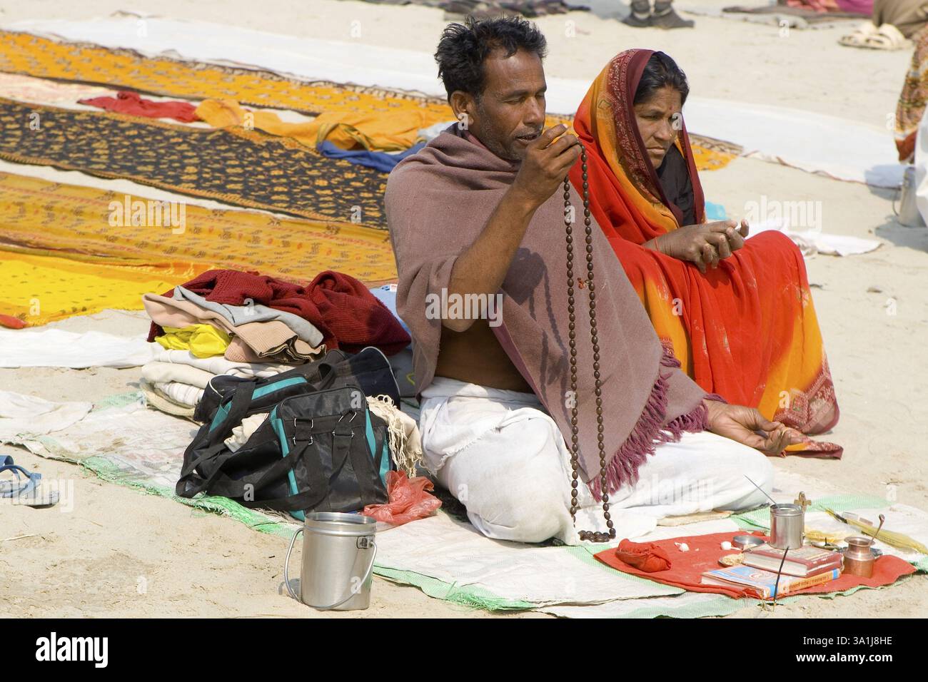Husband and wife worshiping and chanting mala at Kumbh Mela, Allahabad ...