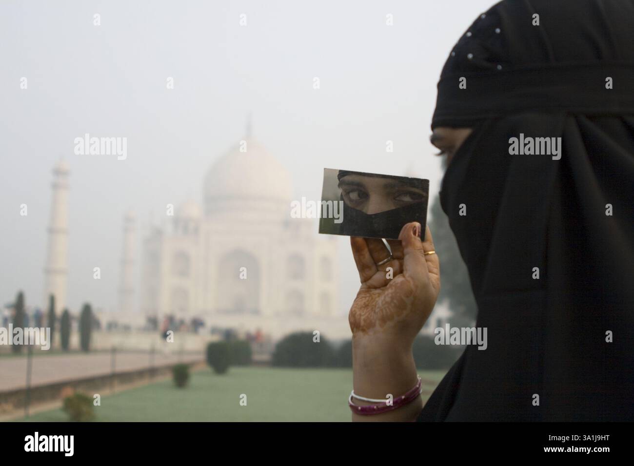 A Muslim woman in front of mogul monument Taj Mahal seven wonder of the ...