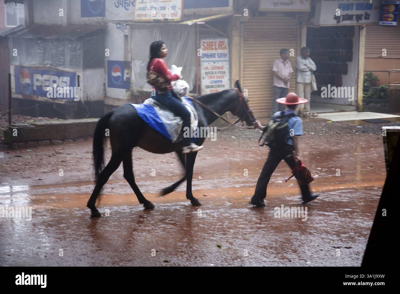 Monsoon, Rainy day woman ride on horse and man pulling them transport ...
