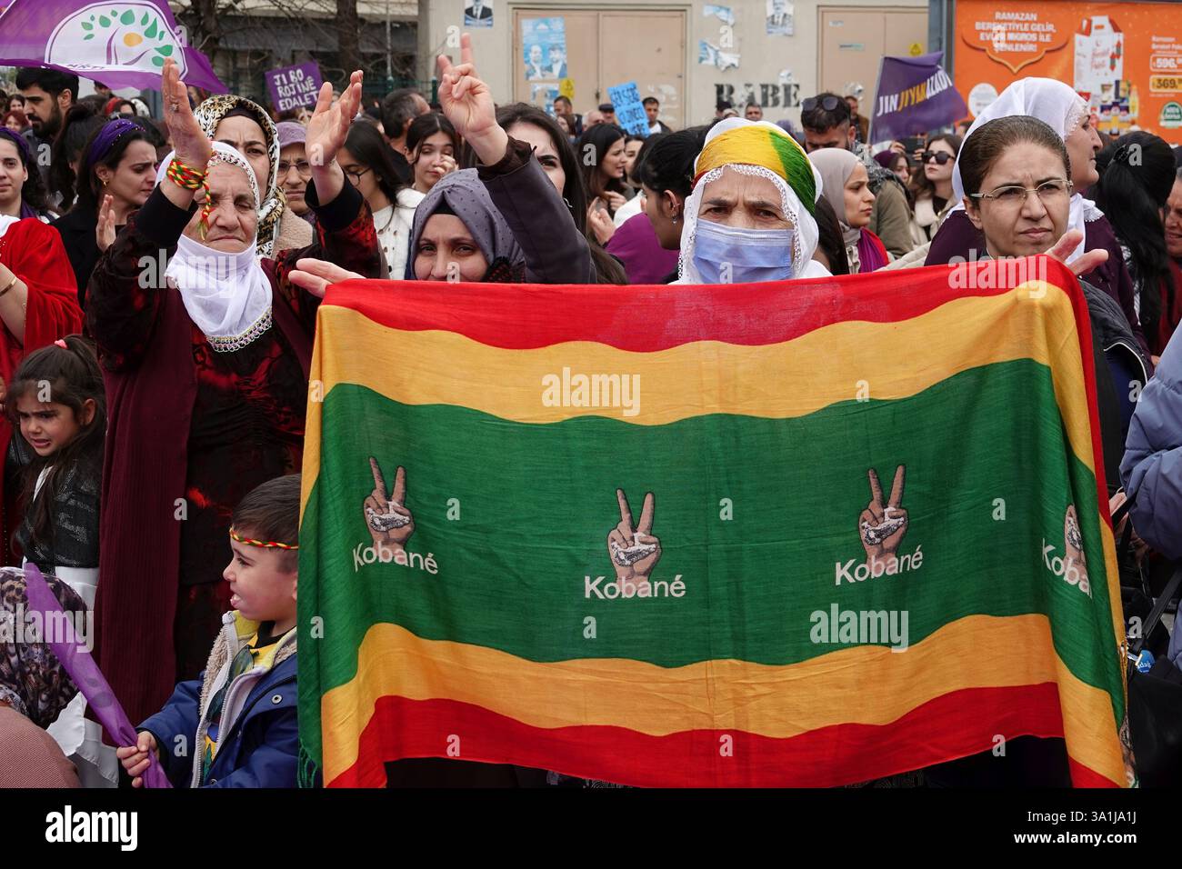 A Kurdish woman is seen holding a banner with the name of the Syrian ...