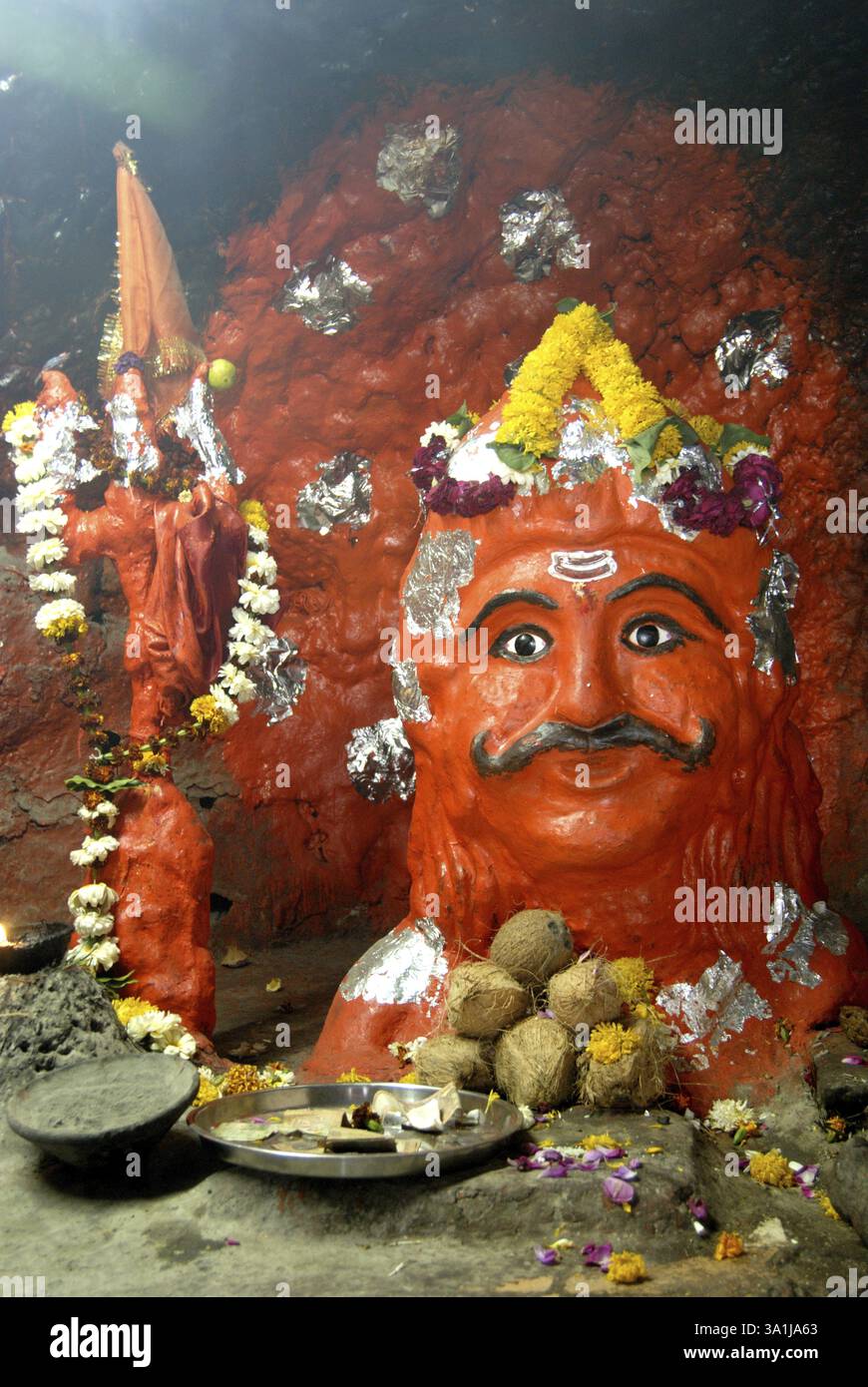 Kal Bhairava close up of Hindu god in cave with coconut, Ujjain, Madhya ...