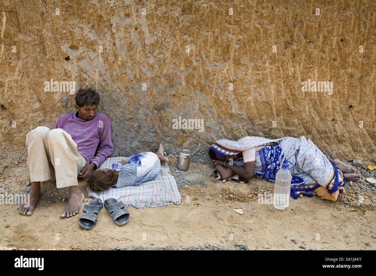 After a lunch break husband and wife taking a nap with their daughter ...
