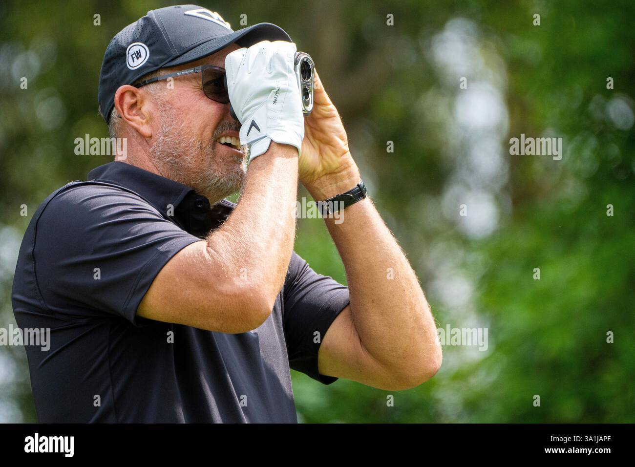 Captain Phil Mickelson of HyFlyers GC reads his yardage on the second ...