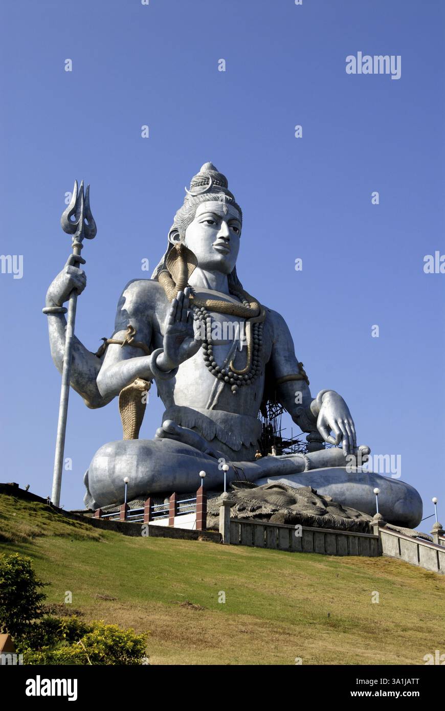 Huge idol of Lord Shiva with snake in neck on small hillock of ...