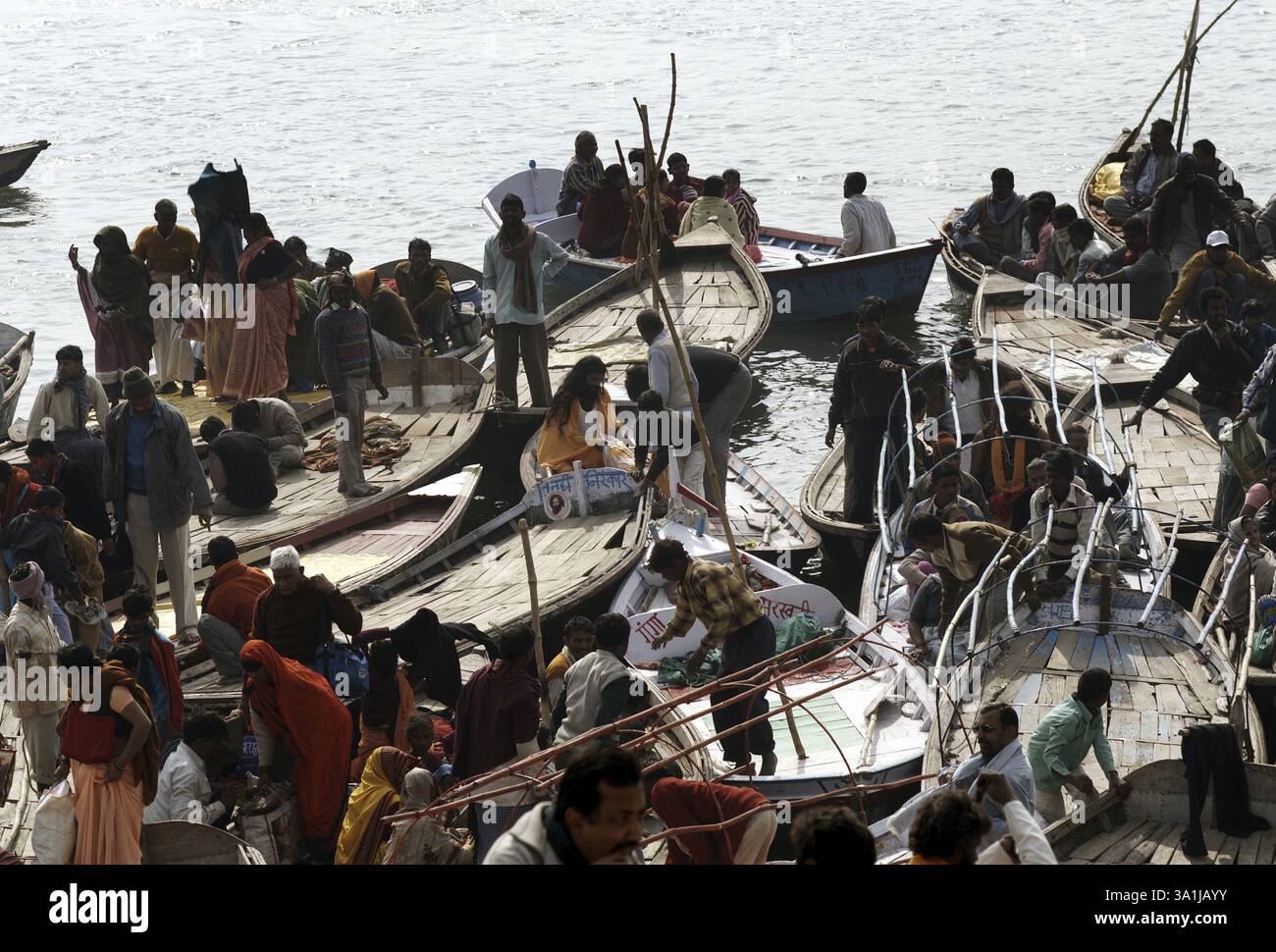 Boats or ferries ferry devotees at the confluence of the Ganges, Yamuna ...