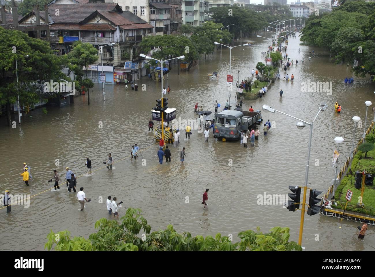 Monsoon, people walking through flooded road heavy rain in Parel ...