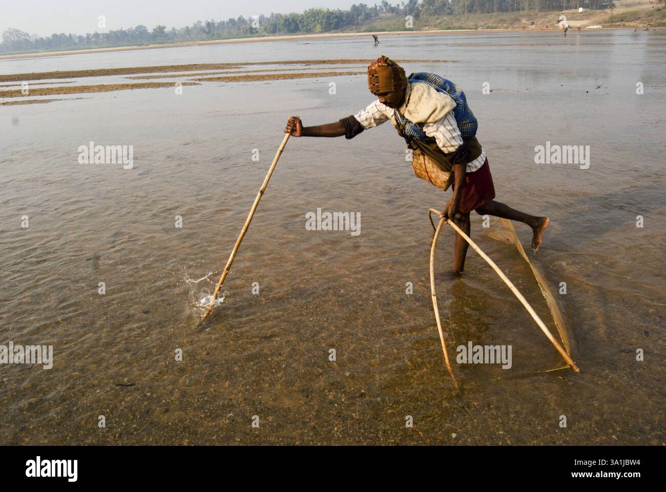 Using special nets tribal fish in the shallow Koel river in the Betla ...