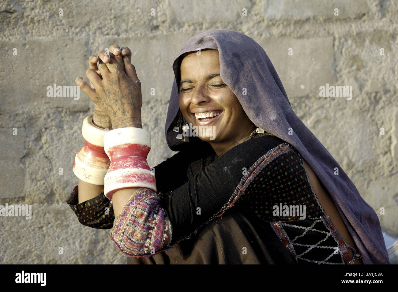 Rabari tribe smiling young lady wearing bangles in Anjar, Kutch ...