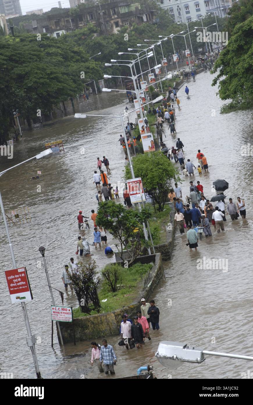 Monsoon, people walking through flooded road heavy rain in Parel ...