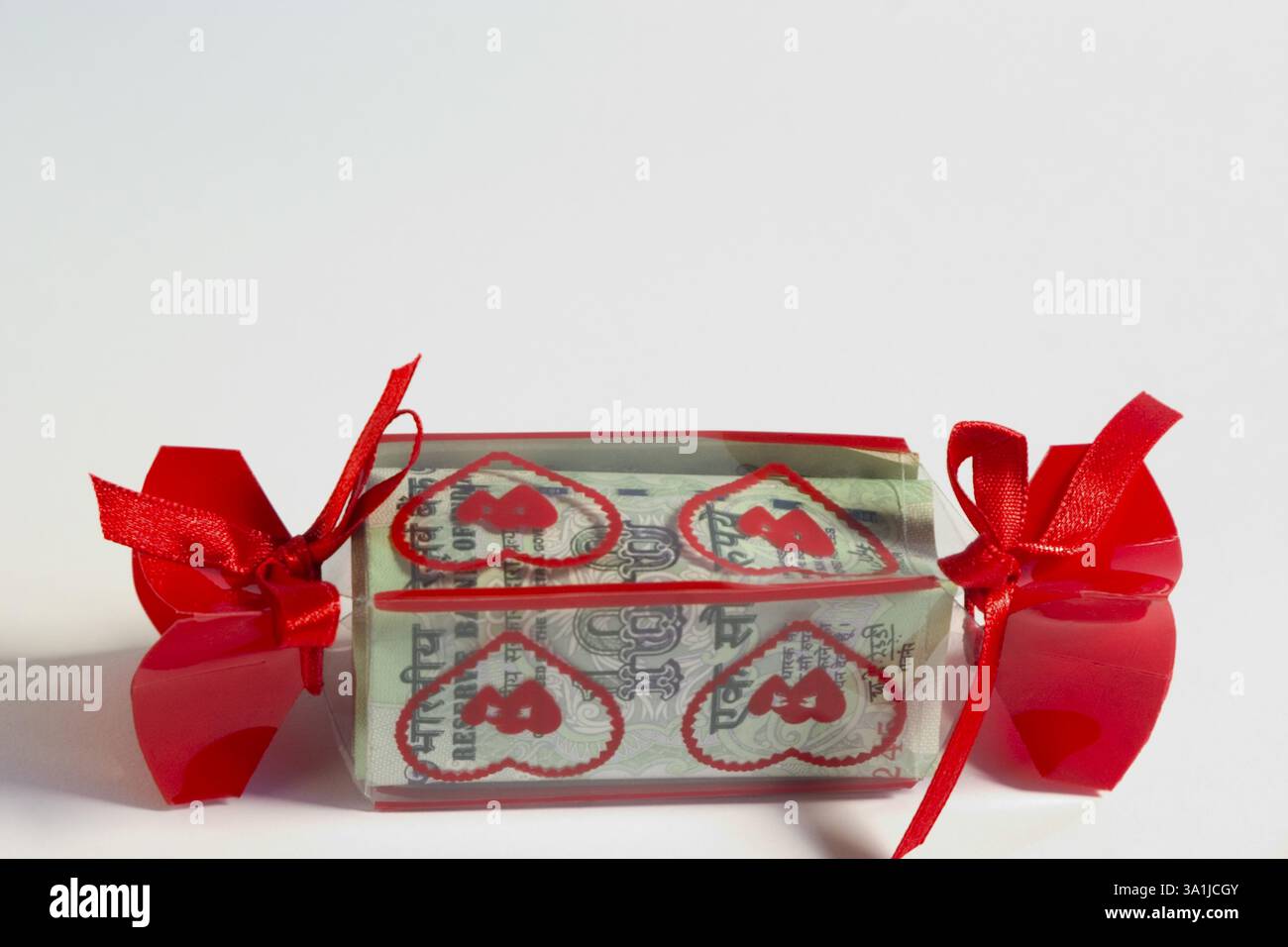 Concept, hundred rupees Indian currency wrap in gift pack on white ...