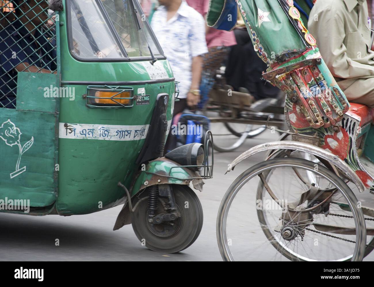Auto rickshaw and Cycle Rickshaw with passengers traveling chaos street scene in Dhaka ...