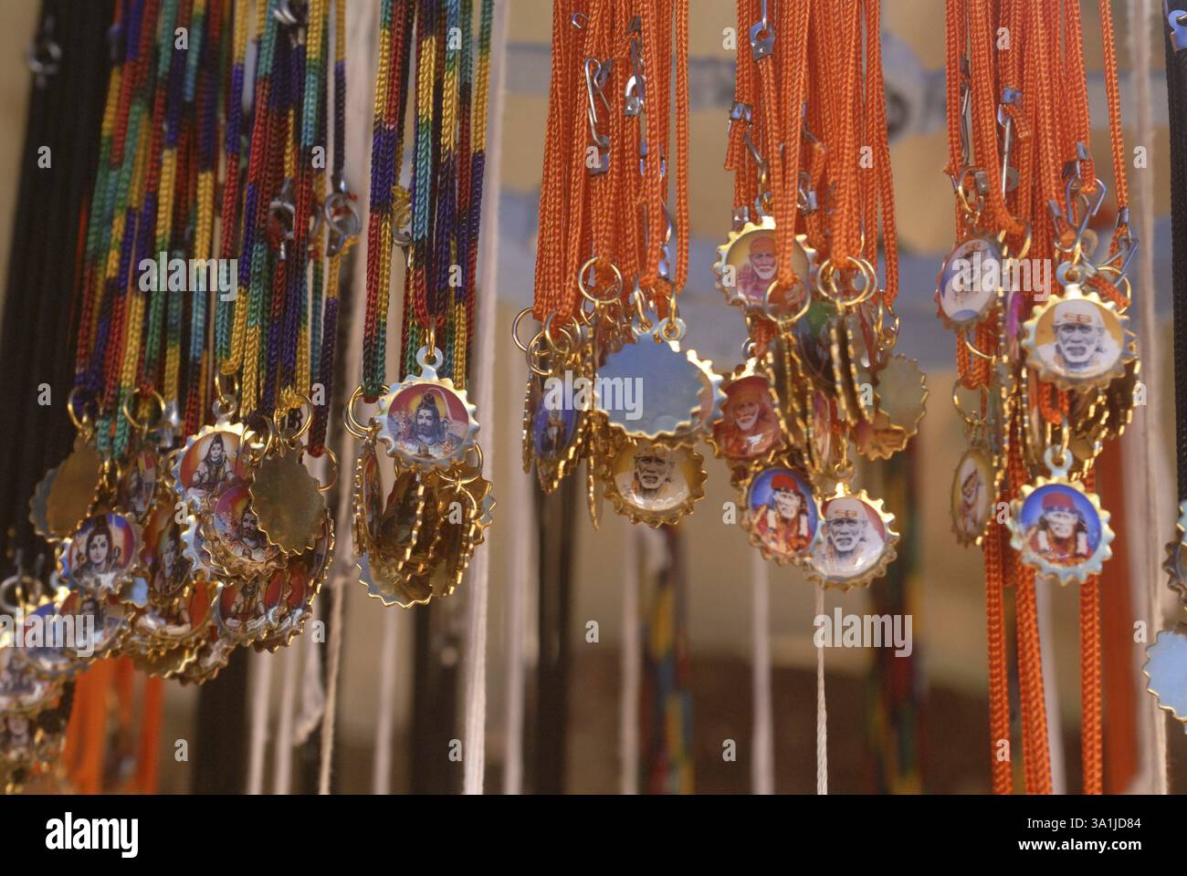 Colorful threads lockets having photo Gods hanging outside typical shop ...