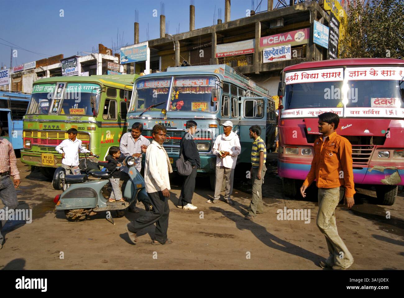 People walk past buses at Bus stop, Jabalpur, Madhya Pradesh, India ...
