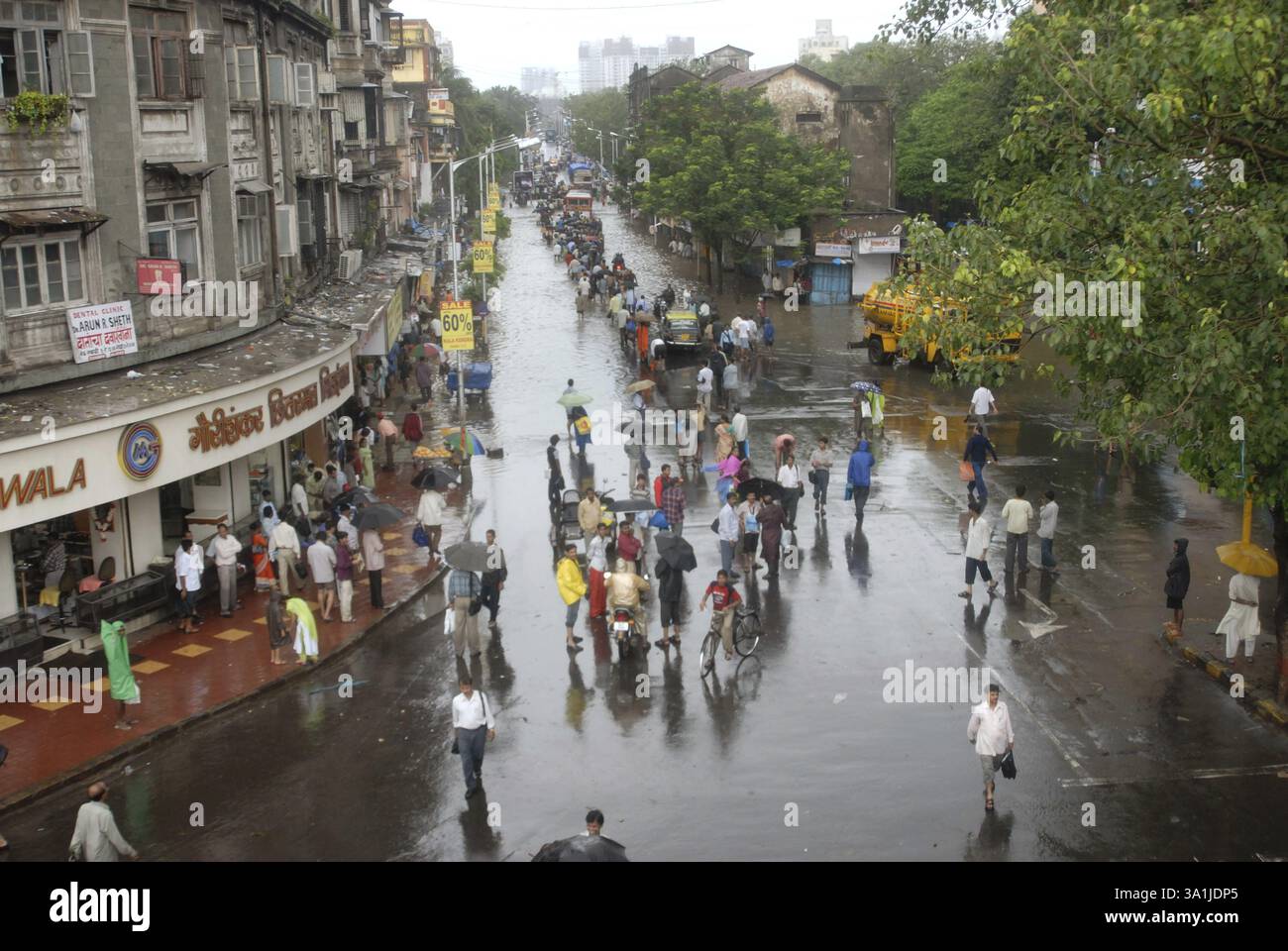 Monsoon, people walking through flooded road heavy rain in Parel ...