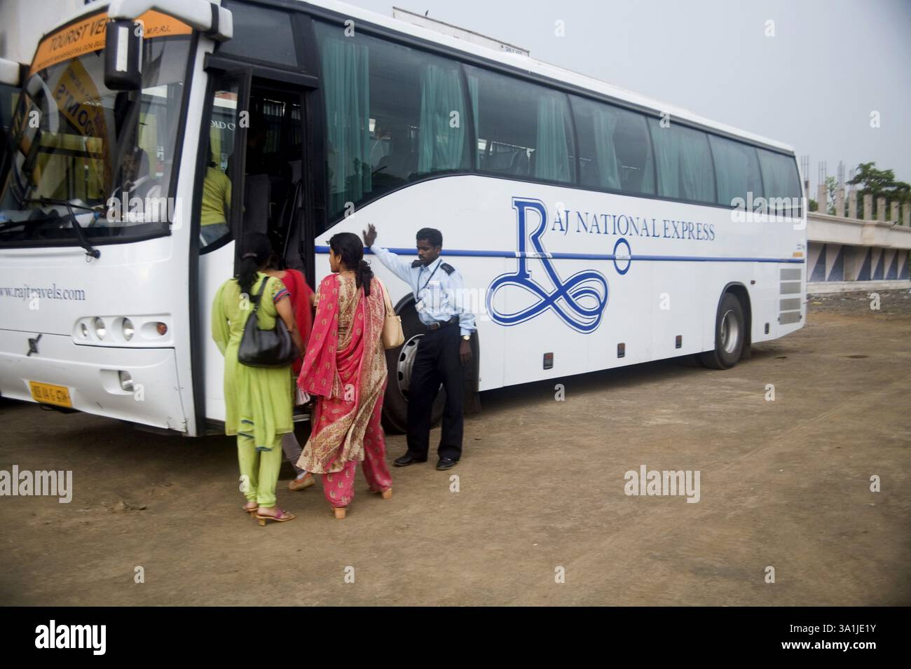 Travel luxury Indian women in Punjabi suit ready to board in white bus ...