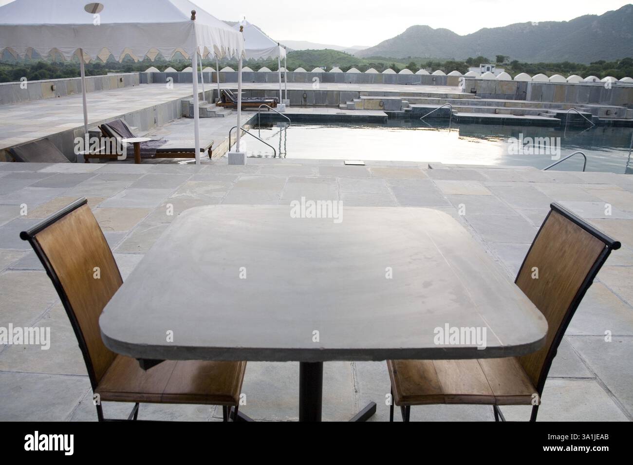 Two chairs table and swimming pool outdoor luxury royal setup in rich ...