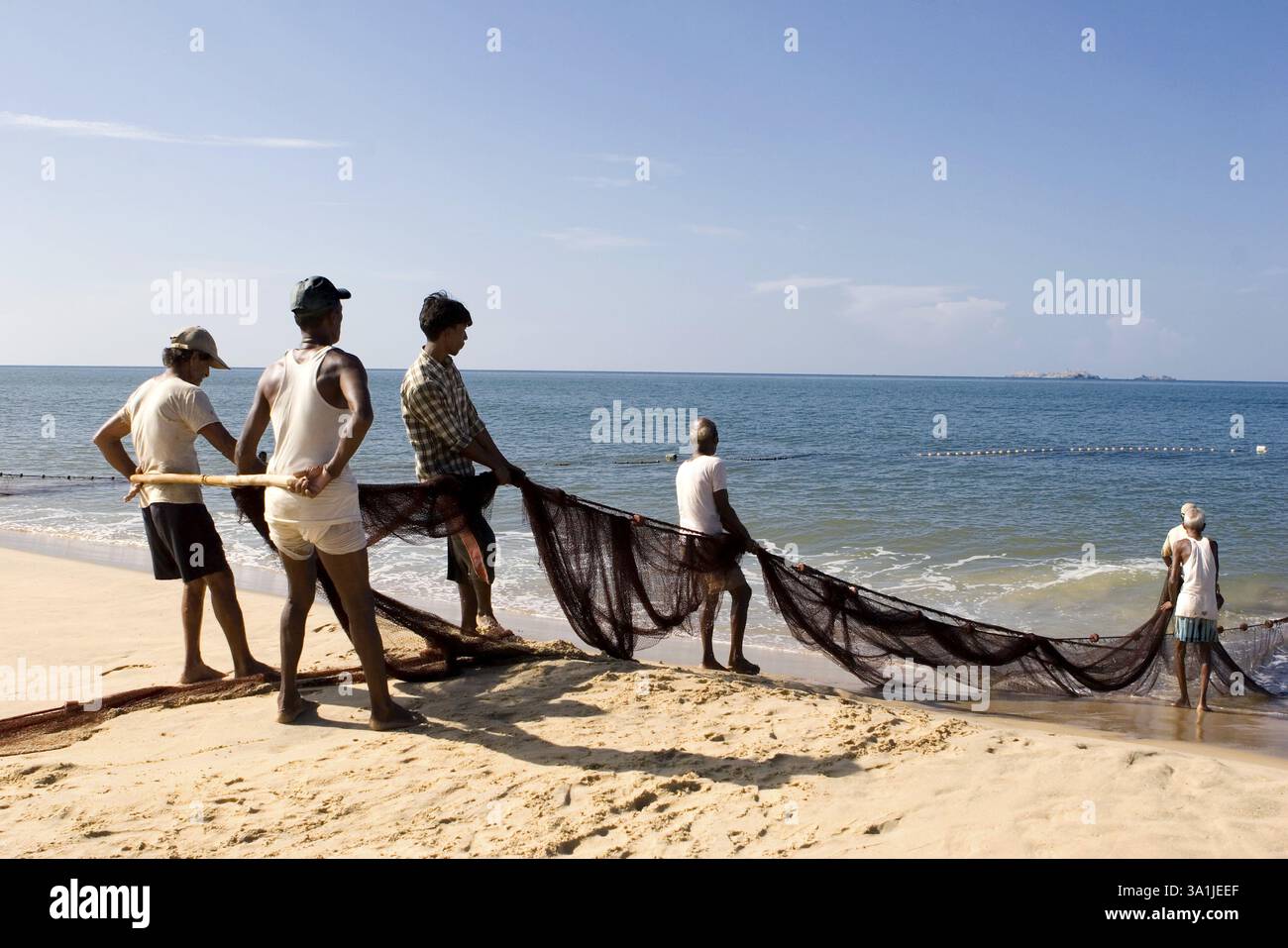 Fishermen pulling big net, Village Bhogwe, Konkan, District Sindhudurga ...