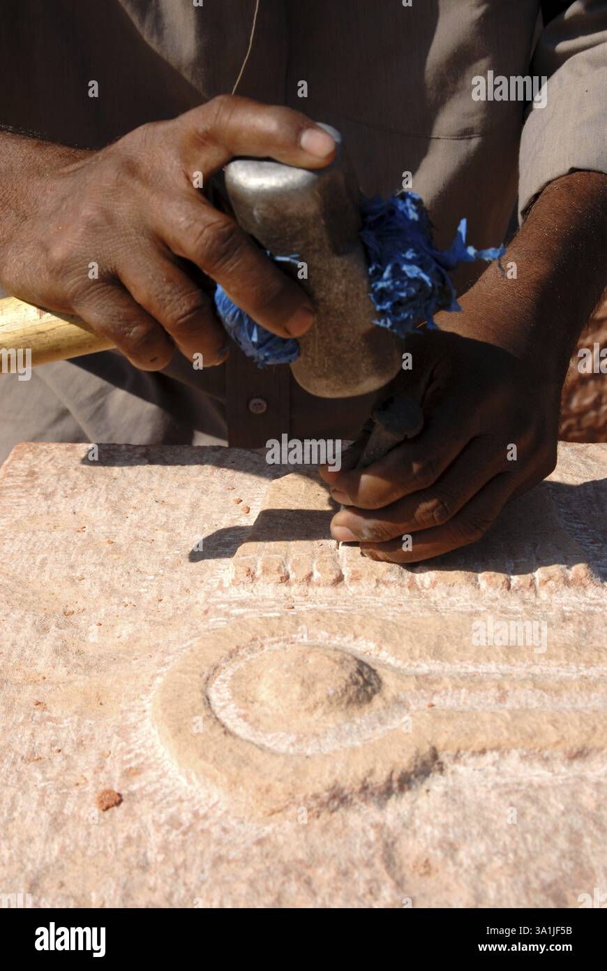Sculpture, man carving stone form of Shivling, Chisser, Sangli ...