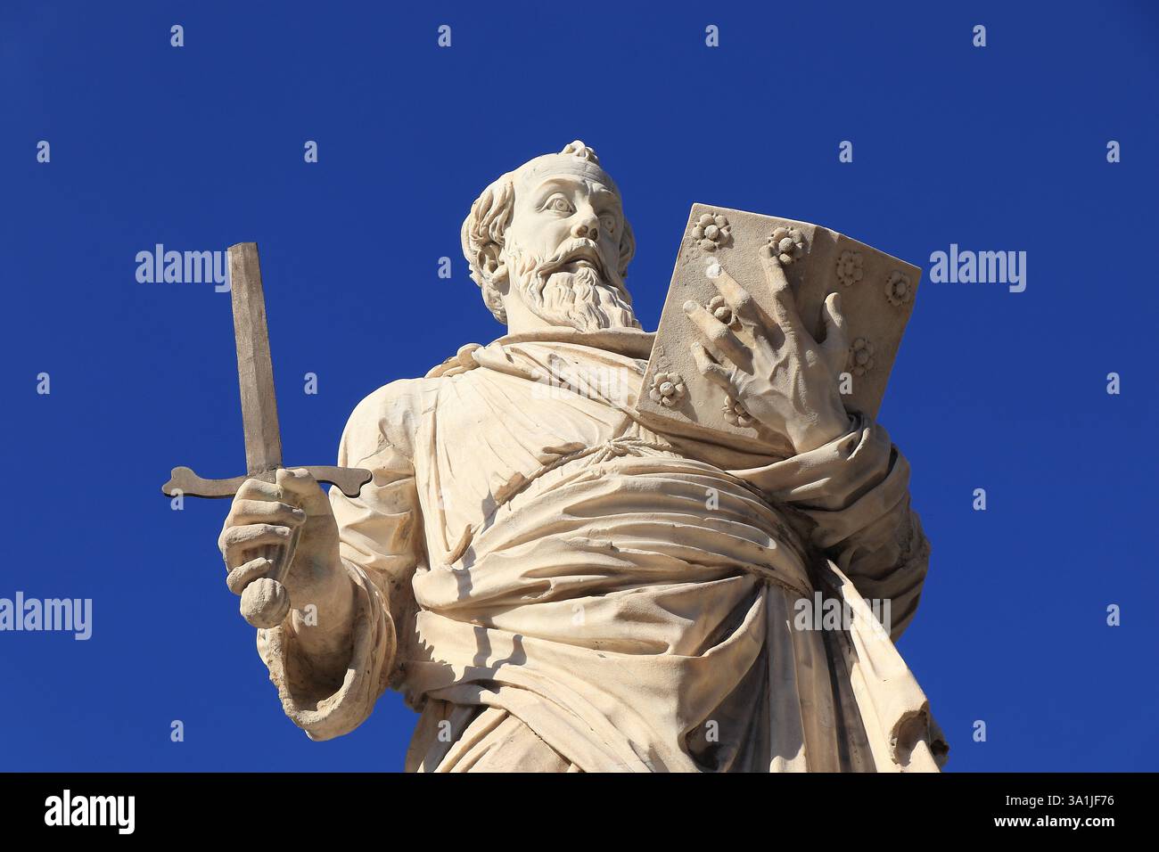 Statue of Saint Paul holding a broken sword and a book decorated with flowers at Ponte Sant ...