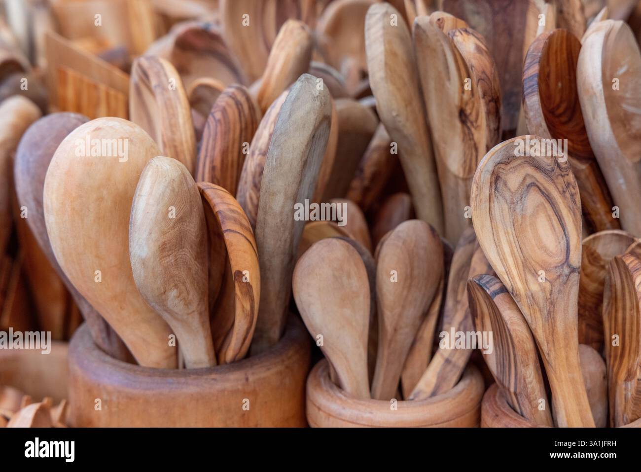 Background of handcrafted wooden spoons in various shapes and sizes ...