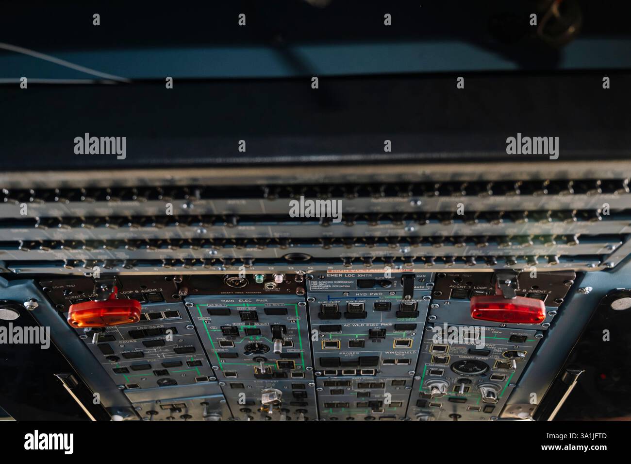 Close-up of a control panel inside an aircraft with a red button at the ...