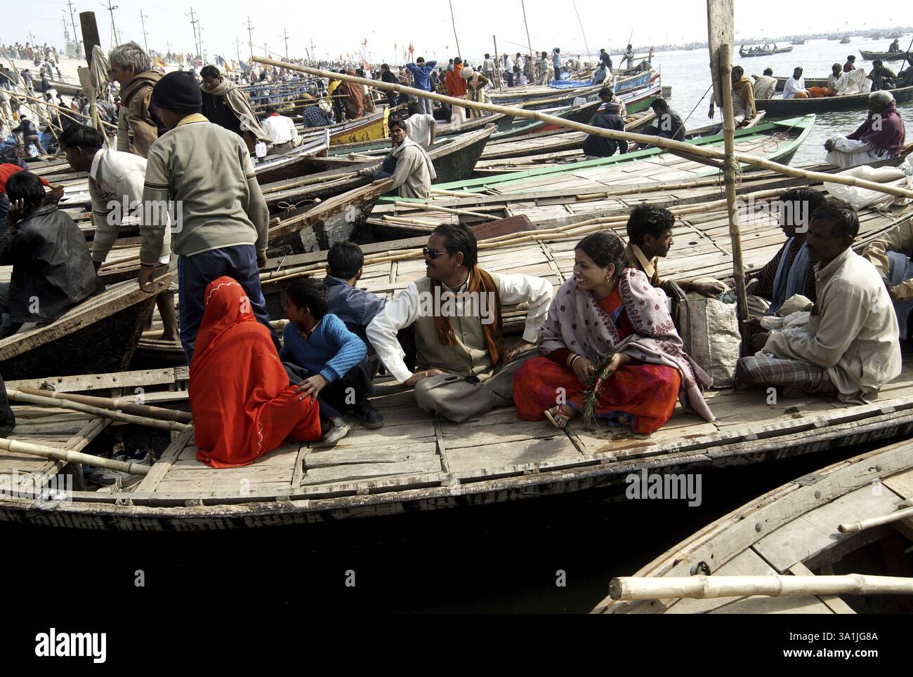 Boats or ferries ferry devotees at the confluence of the Ganges, Yamuna ...