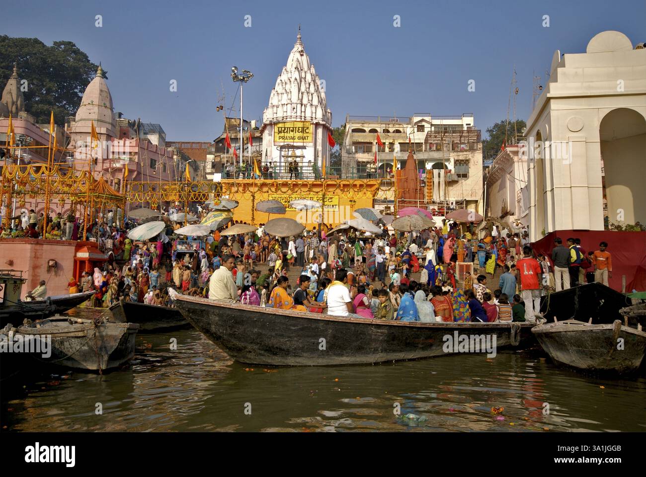 People bathing and taking boat ride in holy Ganga river at Prayag Ghat ...