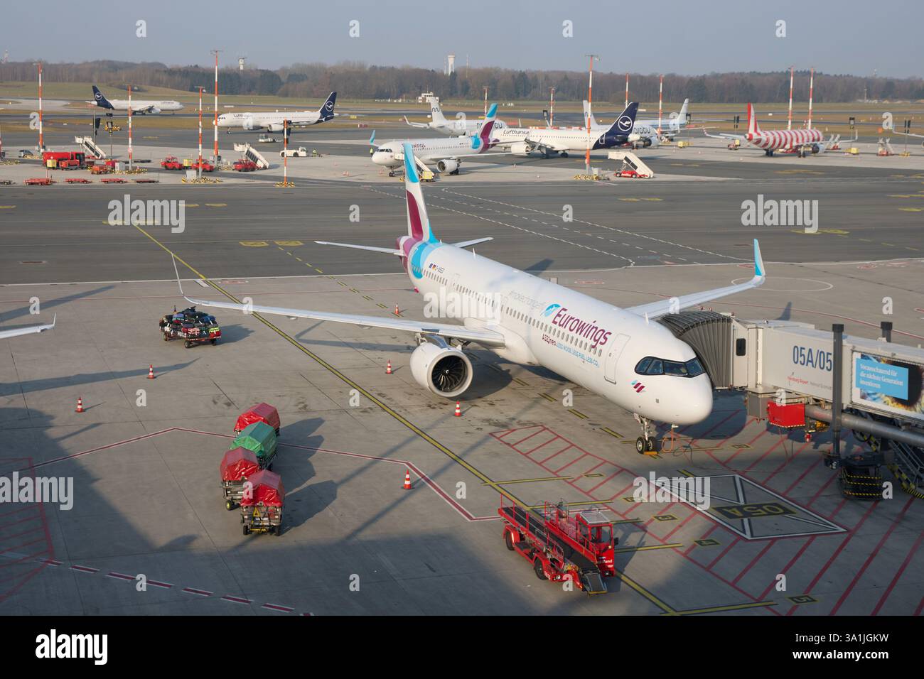 09 March 2025, Hamburg: Luggage stands in front of a Eurowings plane at ...