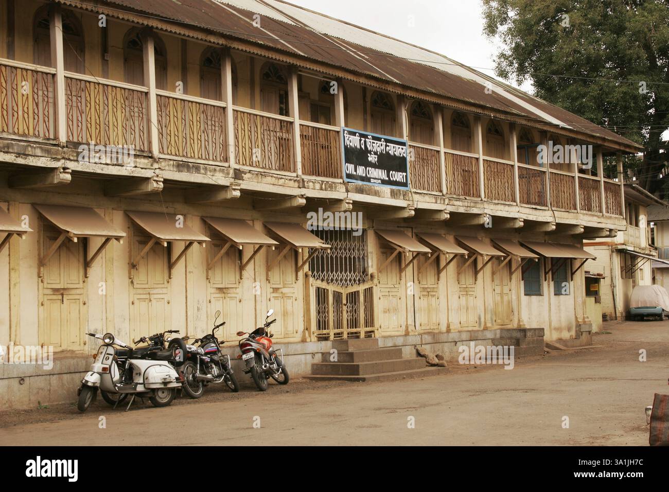 Civil and Criminal Court with a long verandah and several windows ...