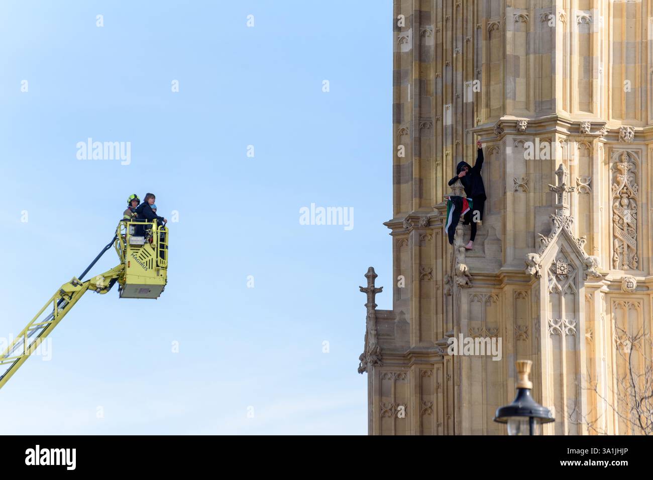 London, UK. 8 March 2025. Pro Palestine man climbs up the Elizabeth ...