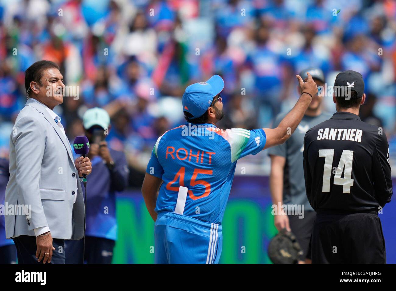 India's captain Rohit Sharma, center, flips the coin at the toss prior ...