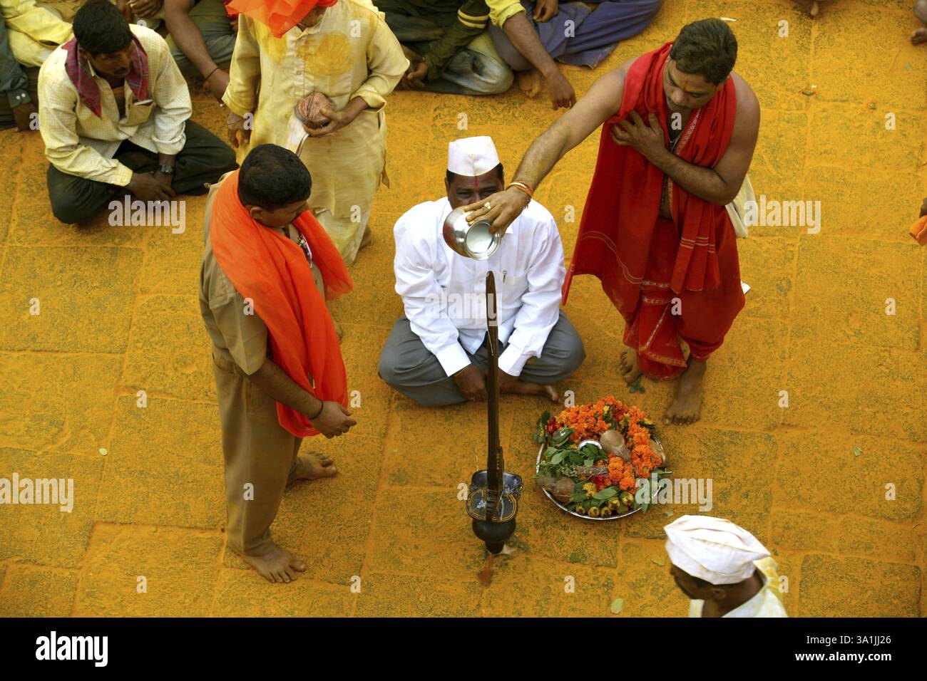 A priest performing pooja of the sword weighing around 50 kg during the ...