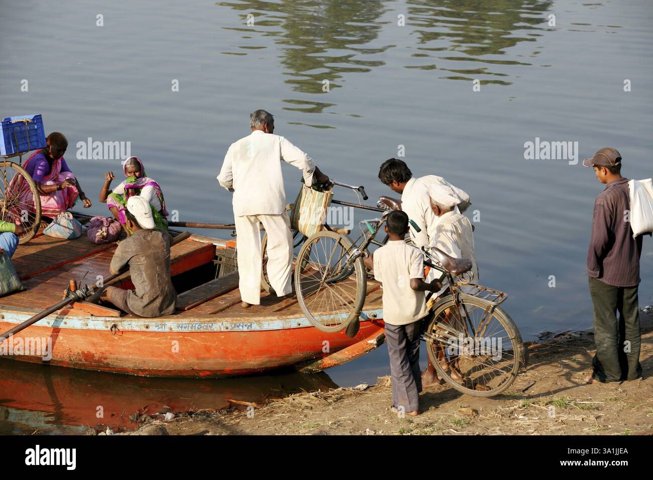 Villagers of the Haripur village loading their bicycles on a boat ...