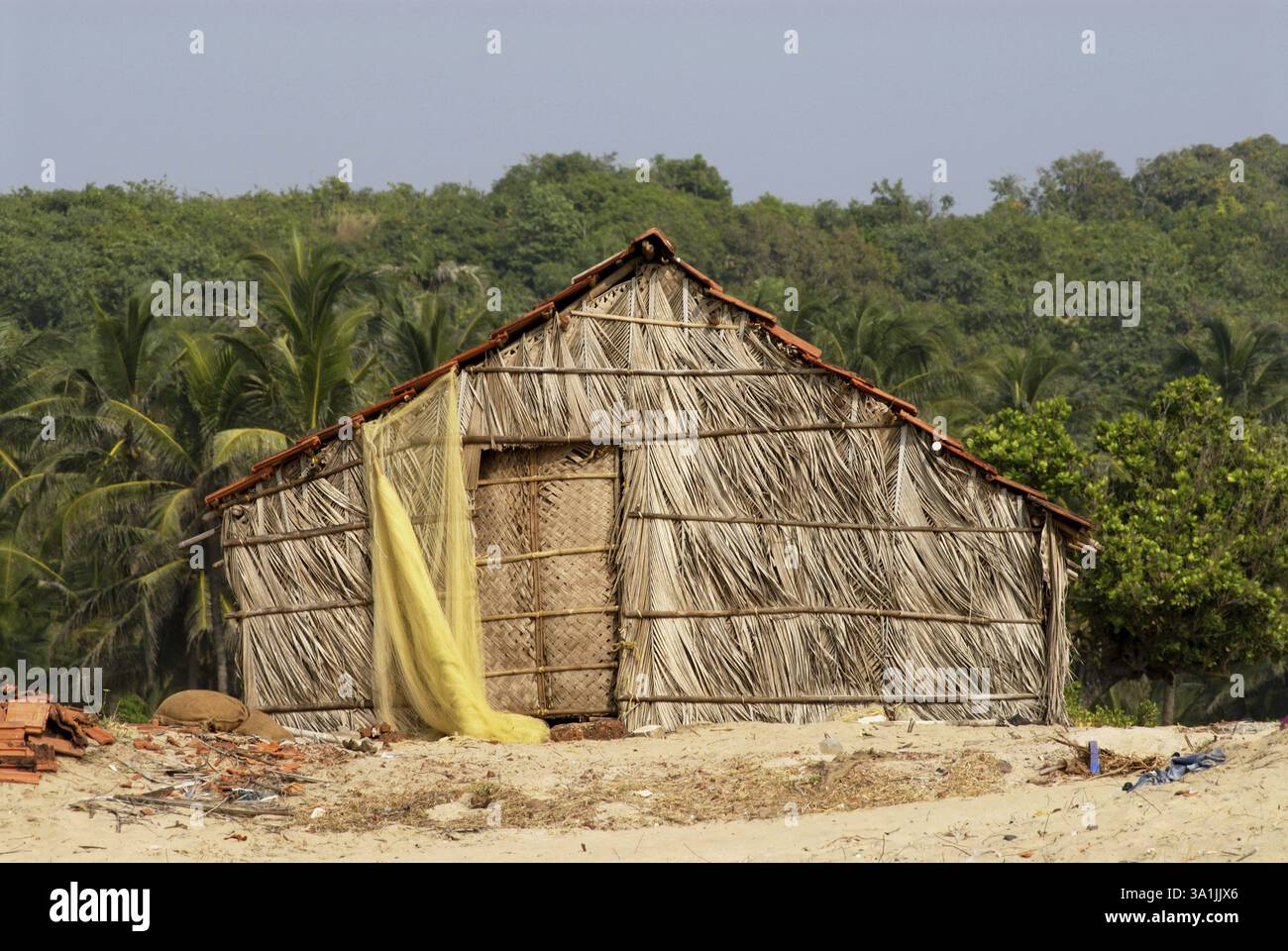Small hut of poor fishermen with fishing net hanging, walls and door ...
