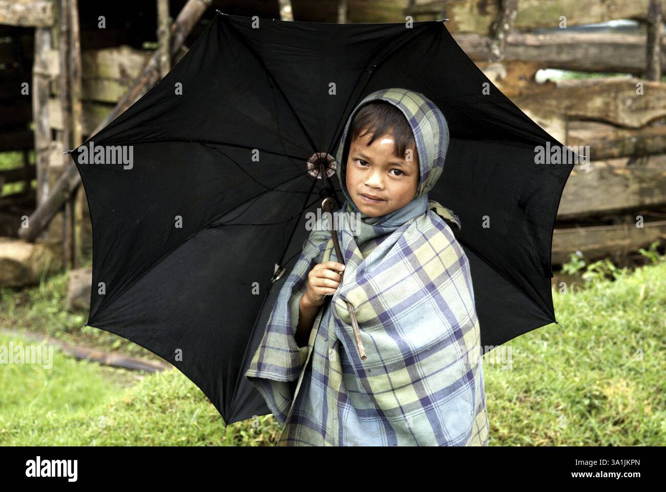 Girl holding black umbrella, the Khasi tribe, Shillong, Meghalaya ...