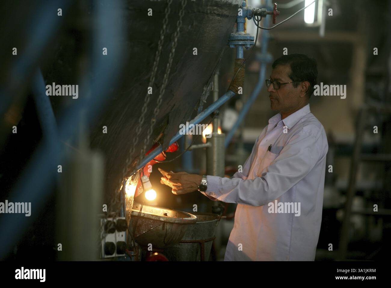 A sugar factory laboratory in charge testing the sugar crystals at the ...