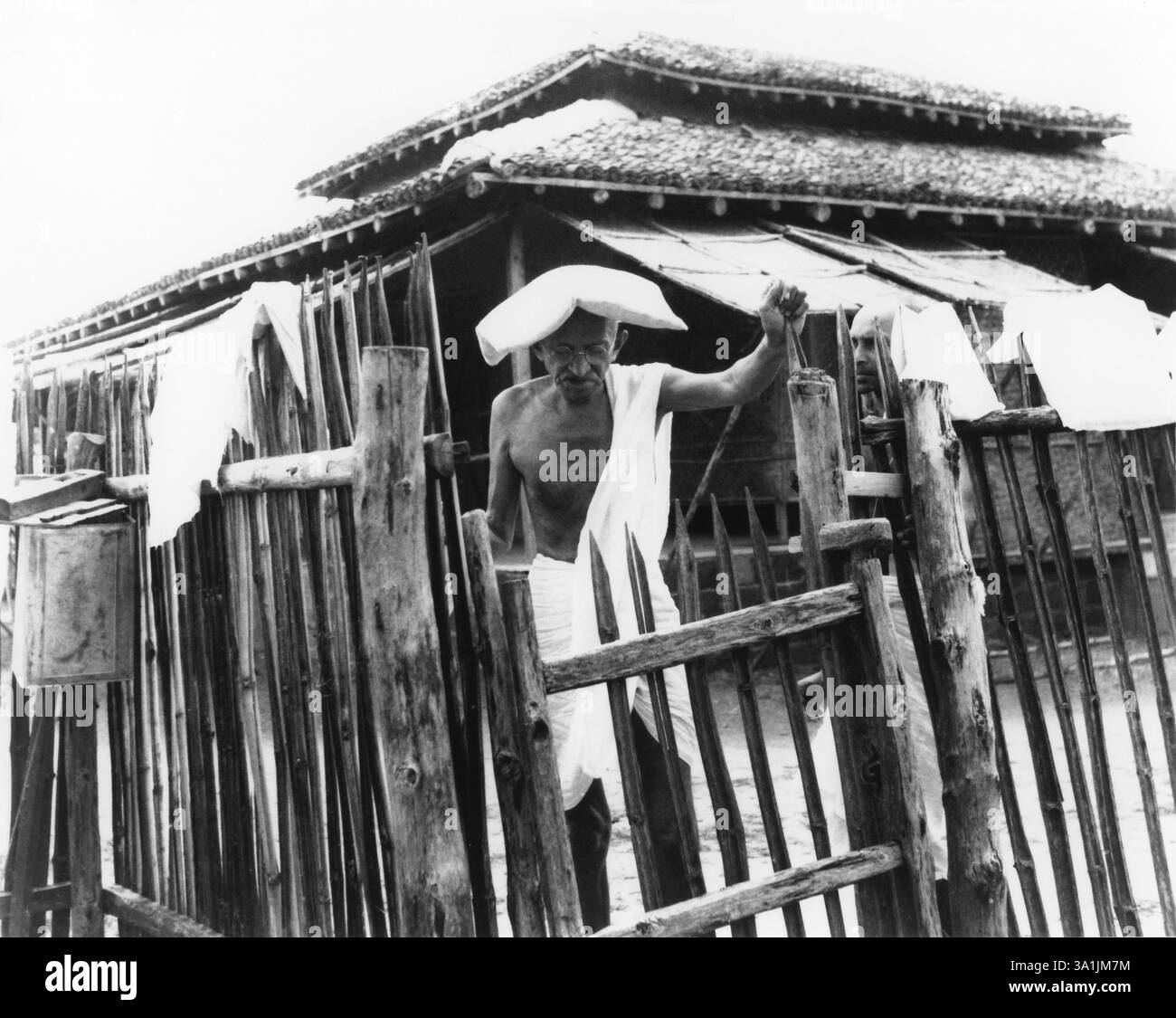 Mahatma Gandhi, carrying a pillow on his head due to severe heat, in ...